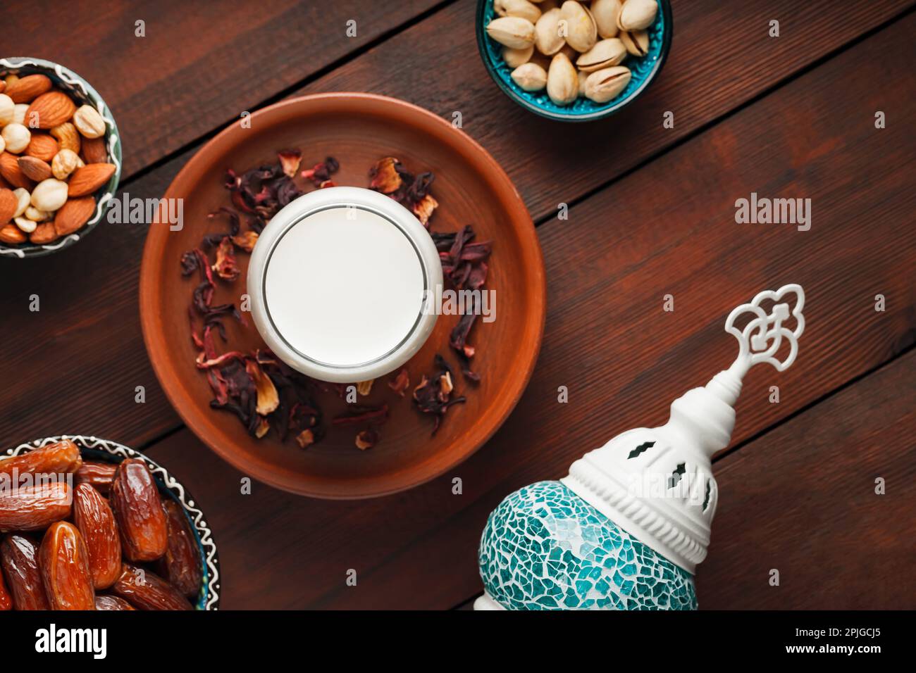 Ramadan Kareem and iftar muslim food. Pitted dates, nuts and milk on ...