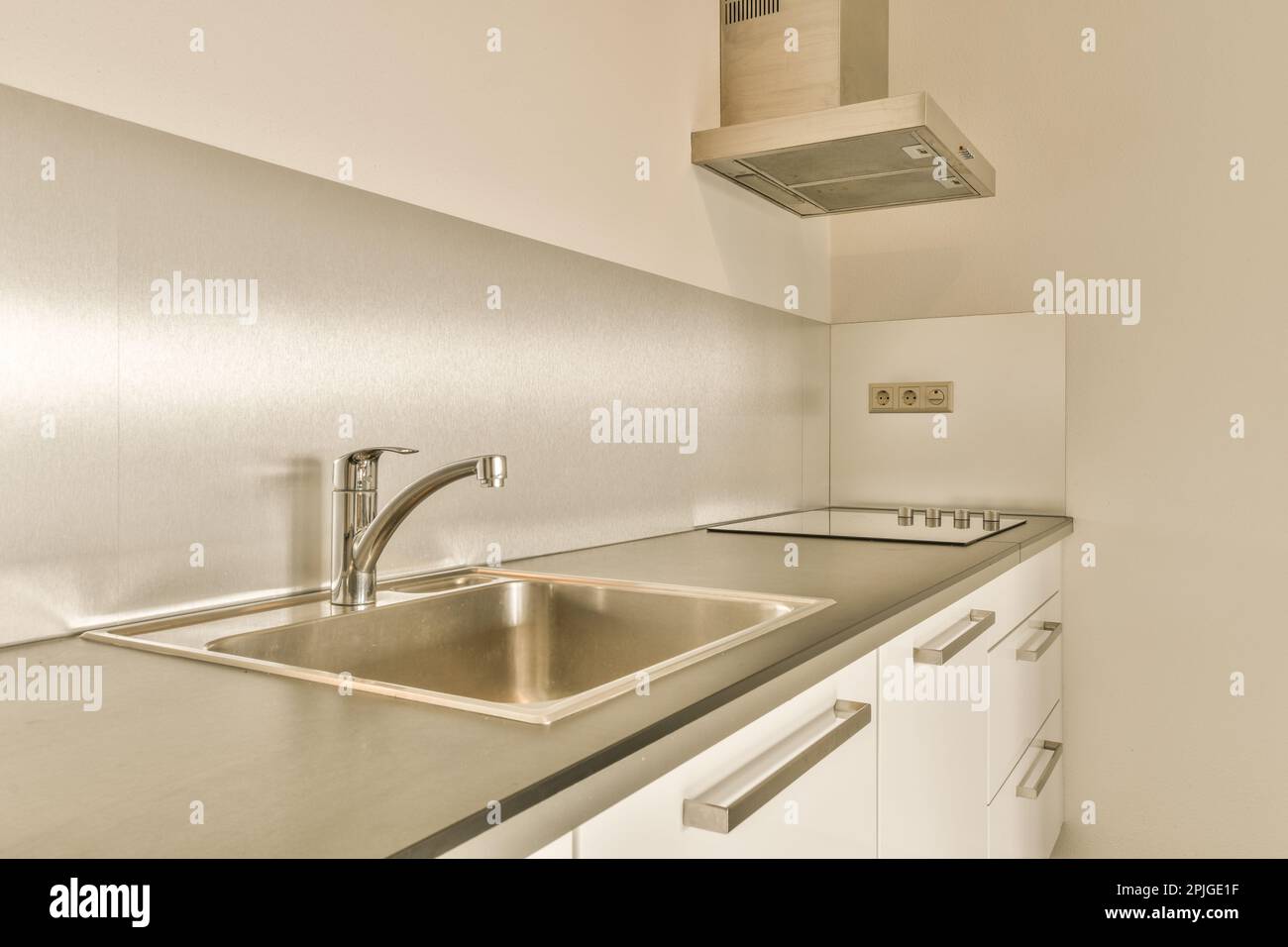 a kitchen area with a sink and stove in the corner, taken from above it ...