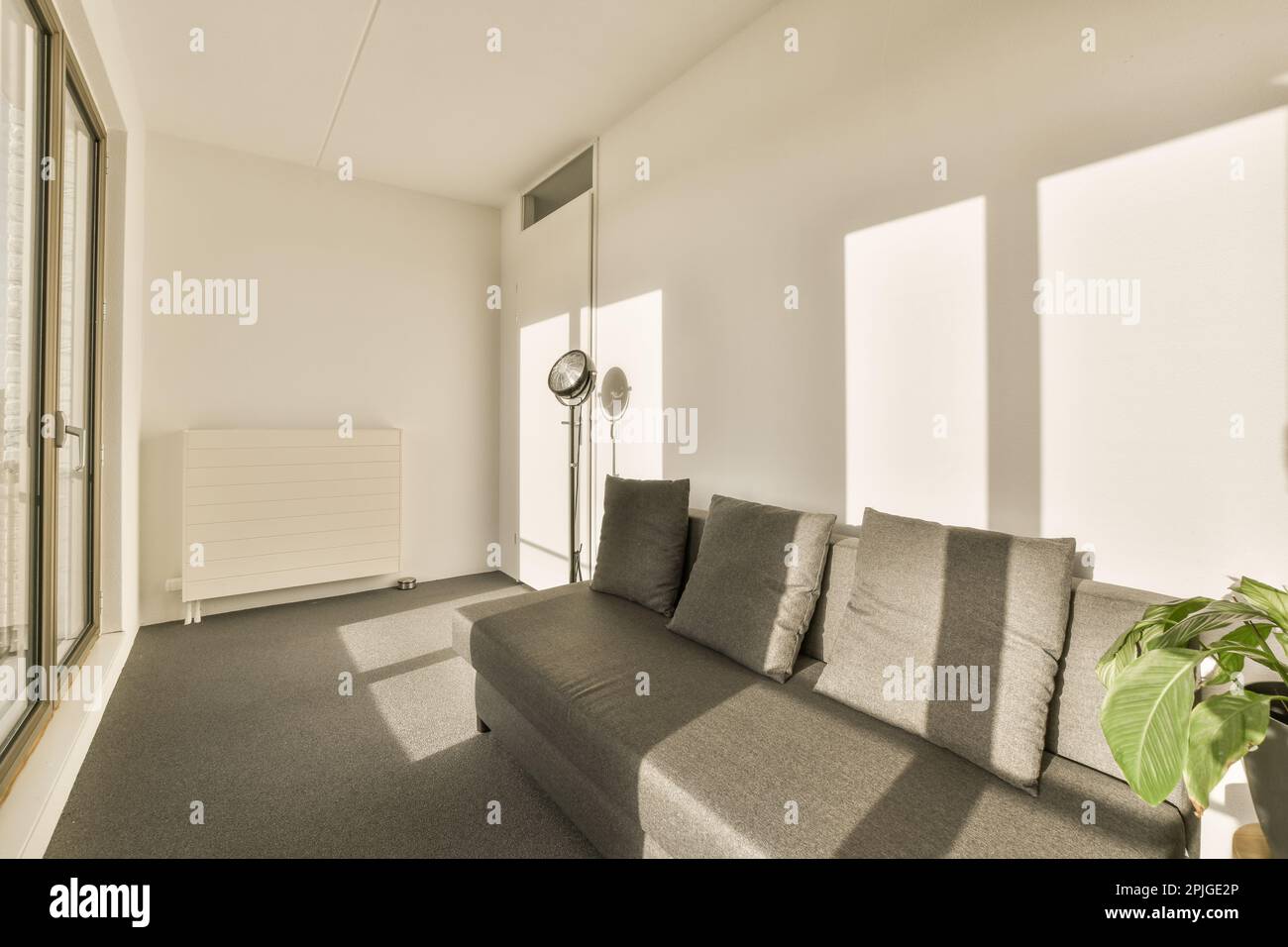 a living room with a couch and large window looking out onto the ...