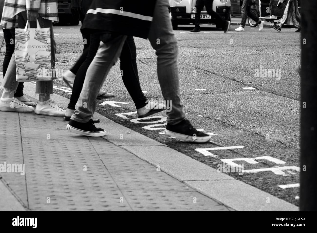 Feet moving very fast on the streets of central London. Motion blur for ...