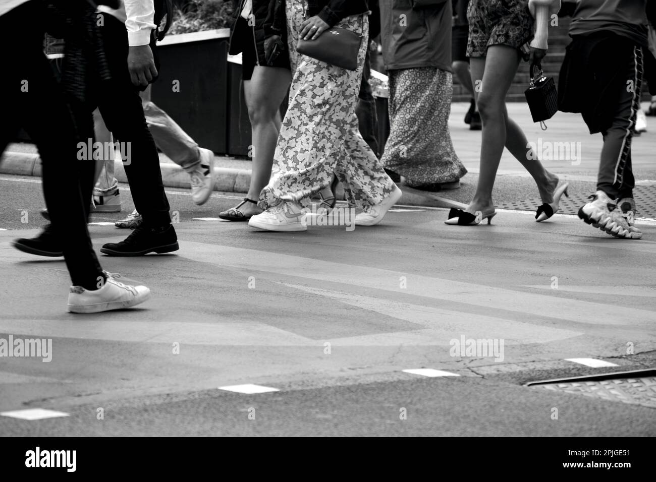 Feet moving very fast on the streets of central London. Motion blur for ...