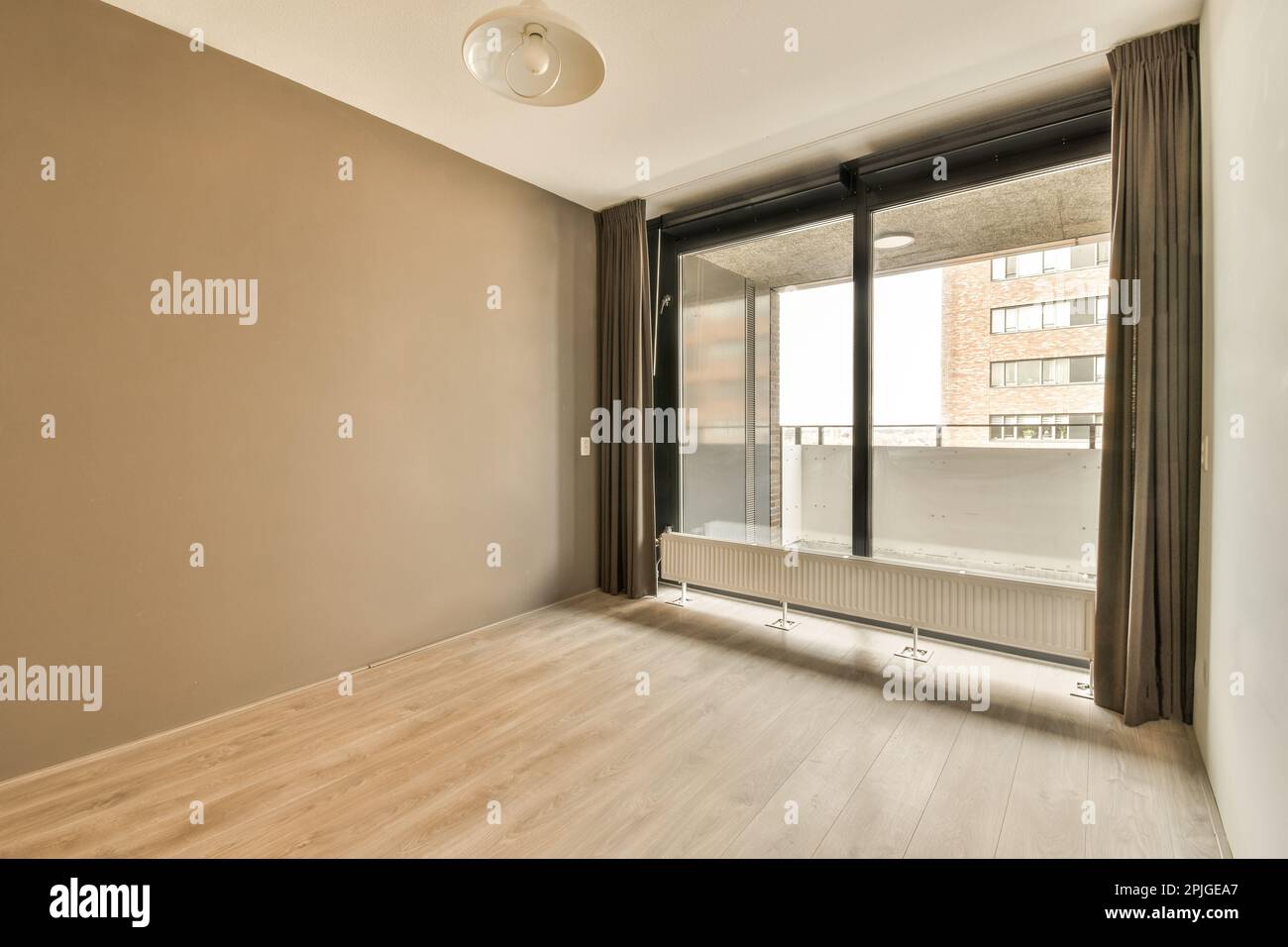 an empty room with wood floor and large window looking out to the ...