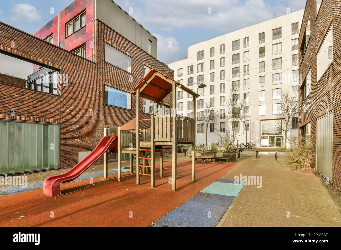 an outdoor play area with a slide in the middle part of the yard, and ...