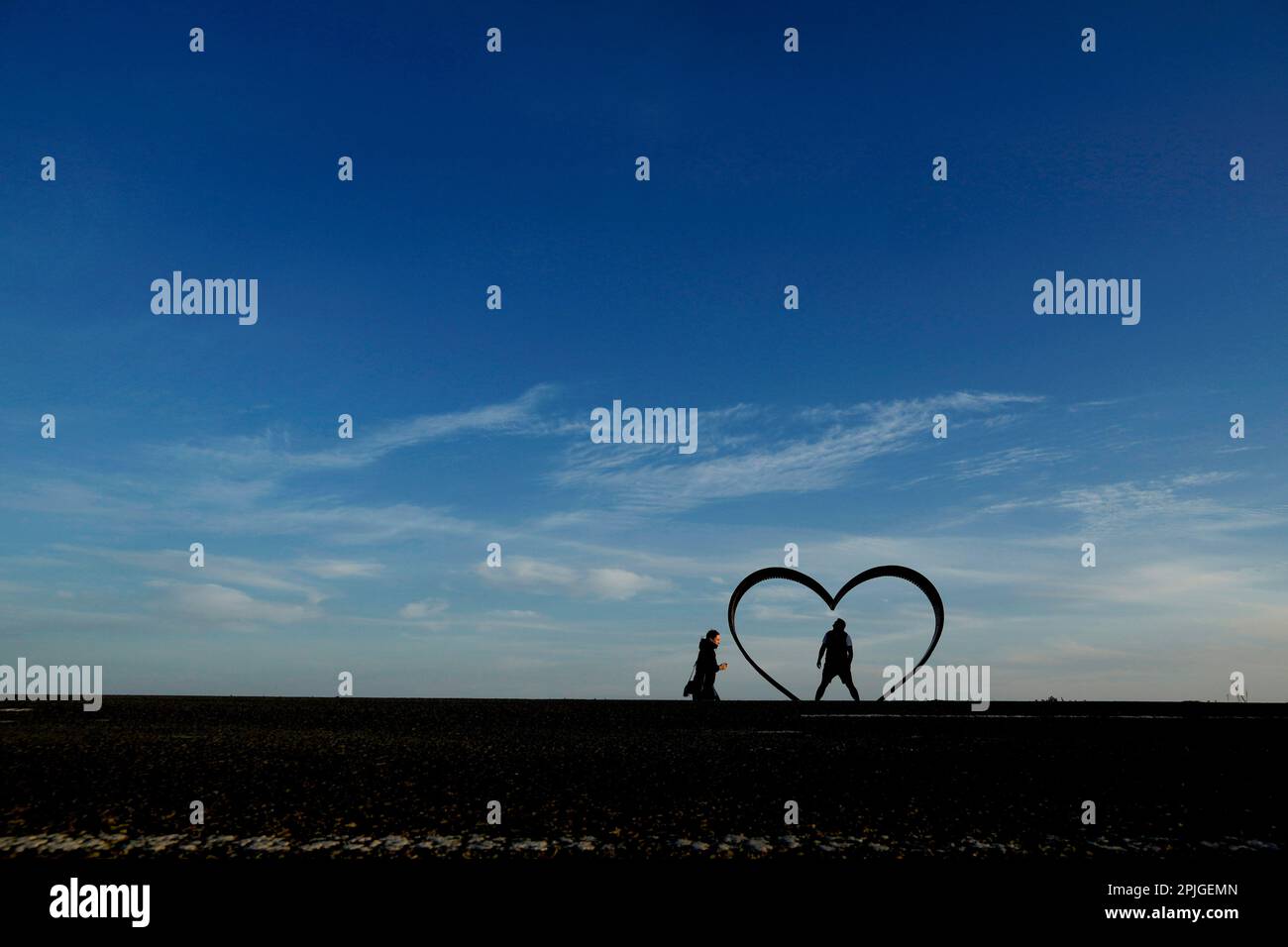 A couple take photos at the heart sea view point at Agios Theodoros ...