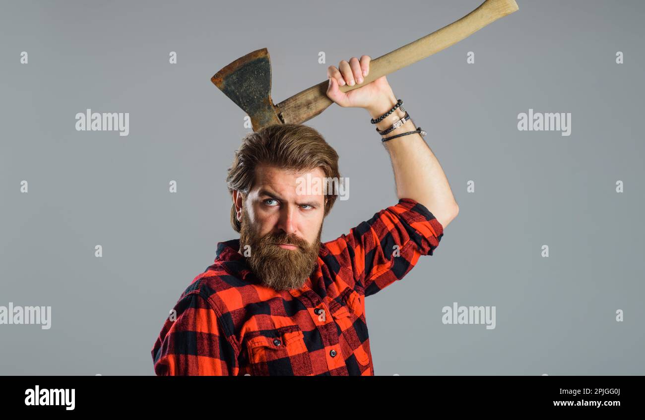 Bearded man with old axe. Man in checkered shirt use axe. Brutal ...