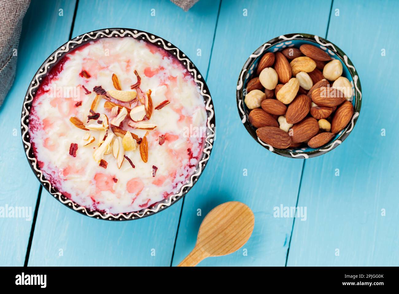 Delicious rice pudding with nuts and rose water. Bowl of indian kheer ...