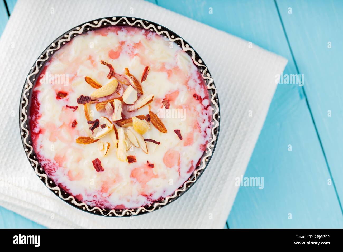 Delicious rice pudding with nuts and rose water. Bowl of indian kheer ...