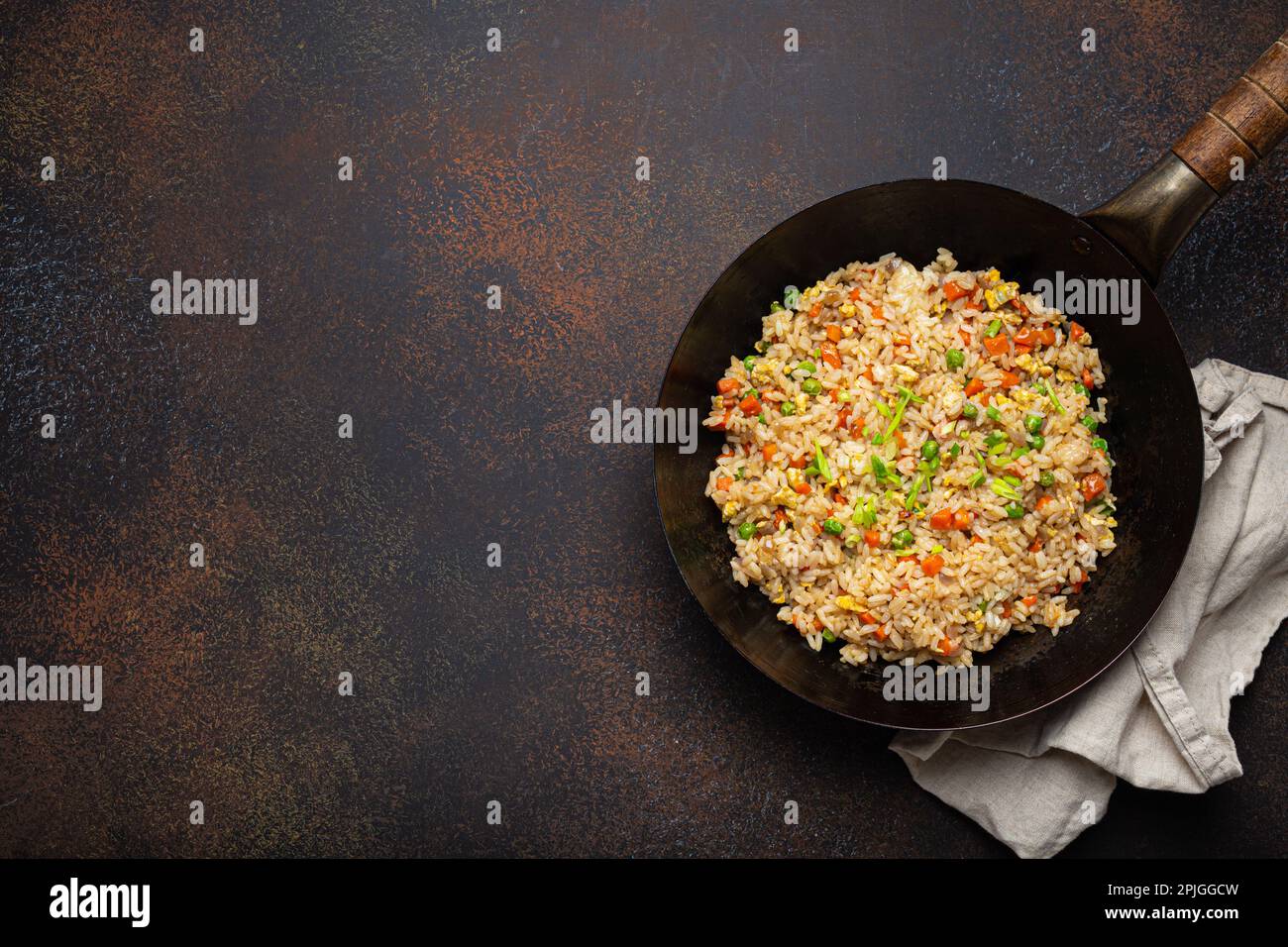 Authentic Chinese and Asian fried rice with egg and vegetables in wok ...