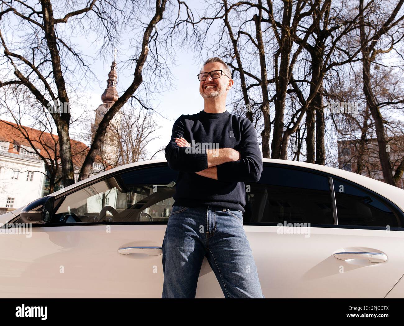 Business man standing next to a new white premium car, the concept of ...