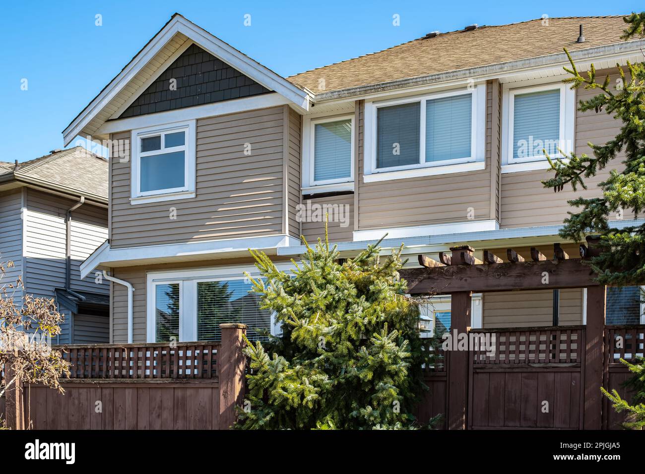 Top of a house with nice windows in the blue sky background. Beautiful ...