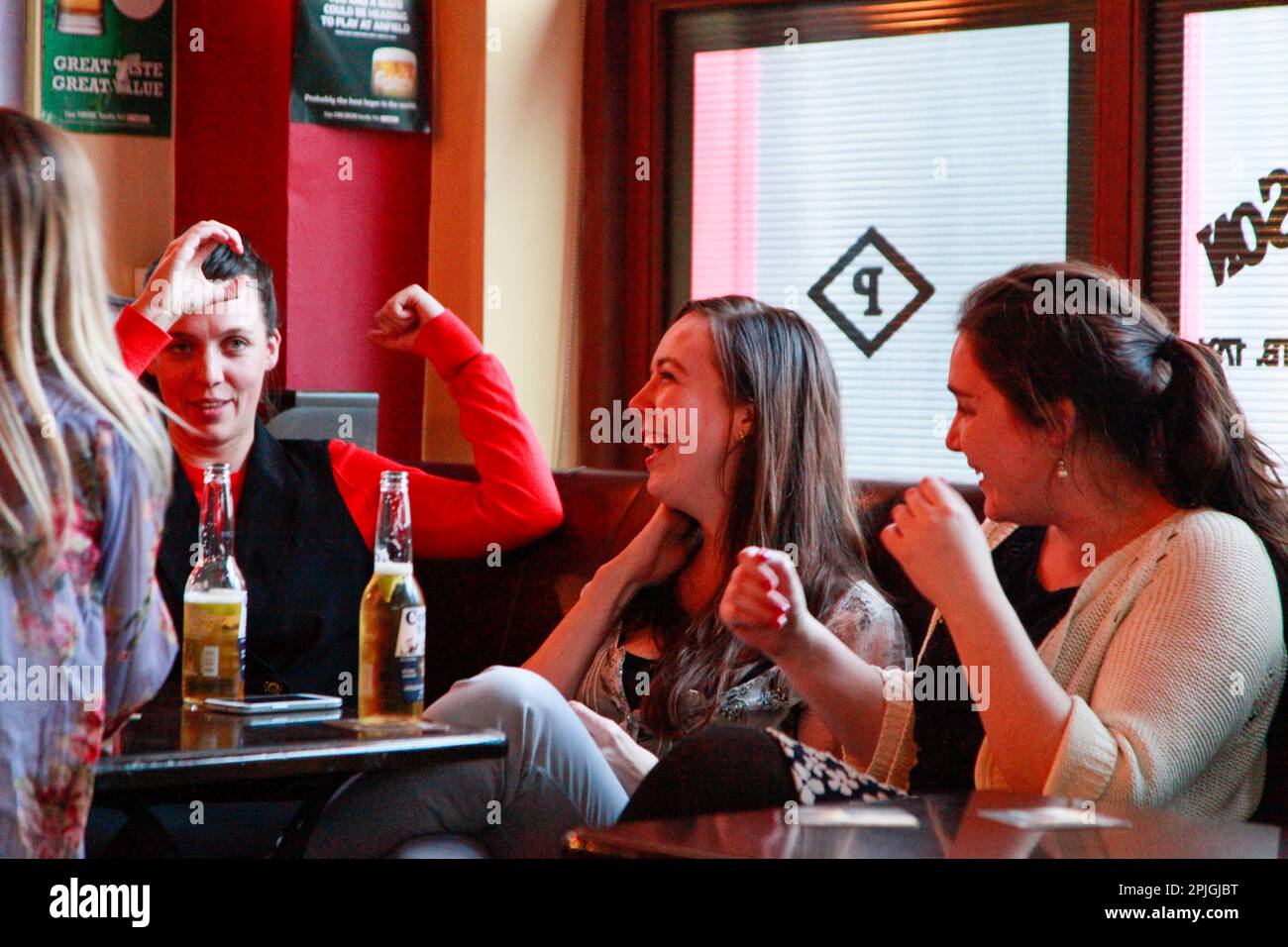 Young women enjoy a joke as they unwind after work in a Dublin, Ireland ...