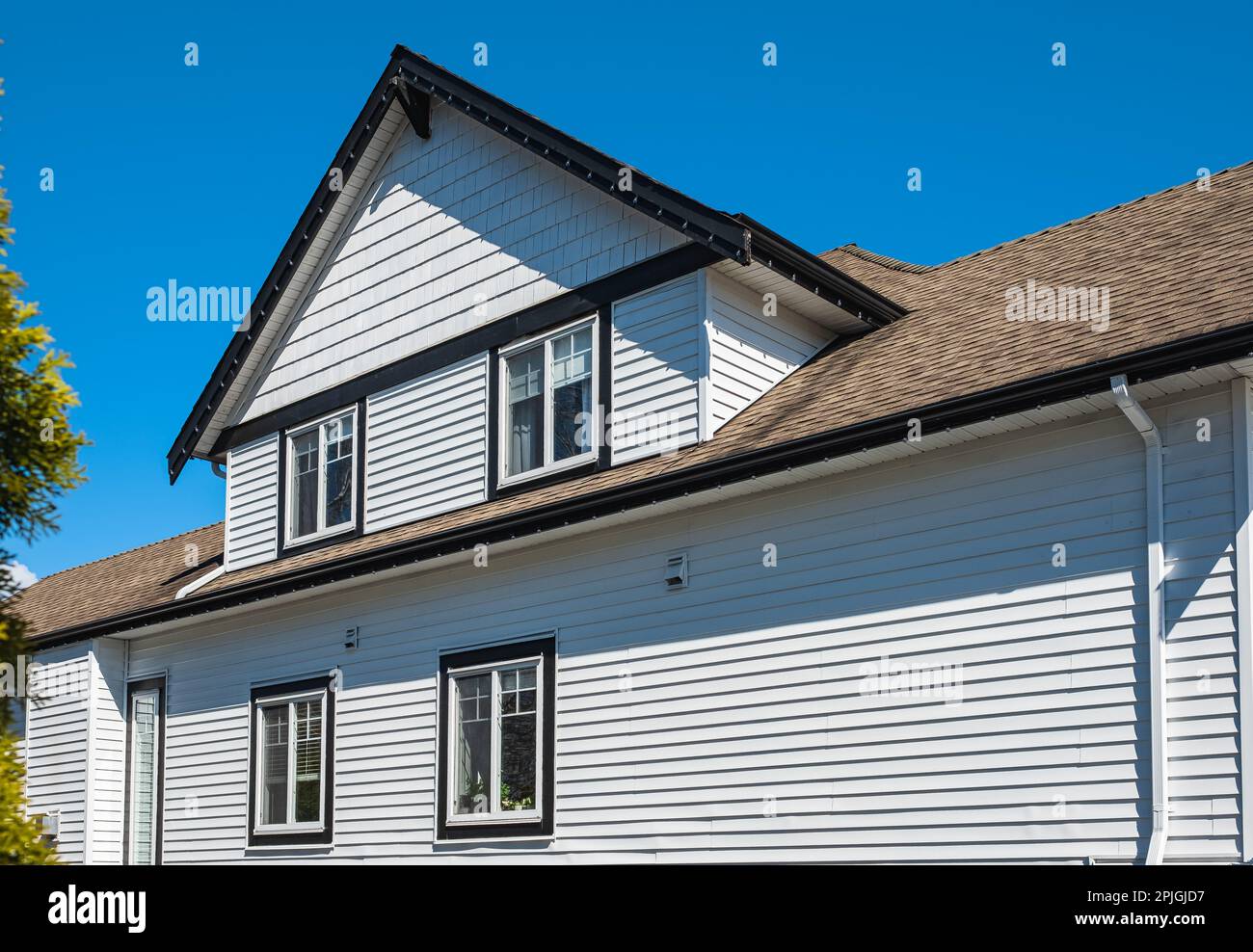 Facade of a house with nice windows in the blue sky background ...