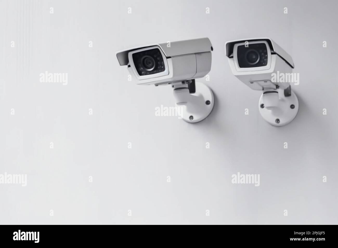 CCTV camera on white wall background Stock Photo - Alamy