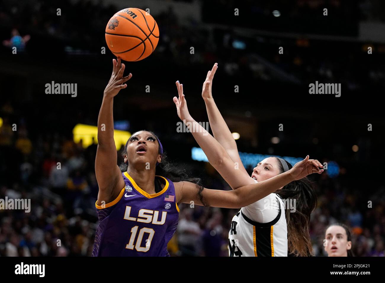 LSU's Angel Reese shoots past Iowa's McKenna Warnock during the first ...