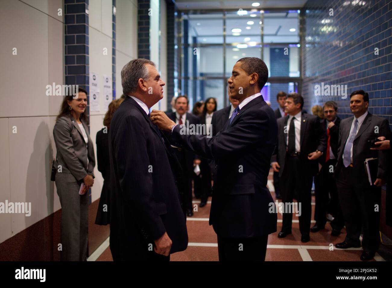 President Barack Obama fixes the tie of Secretary Ray LaHood, as they ...