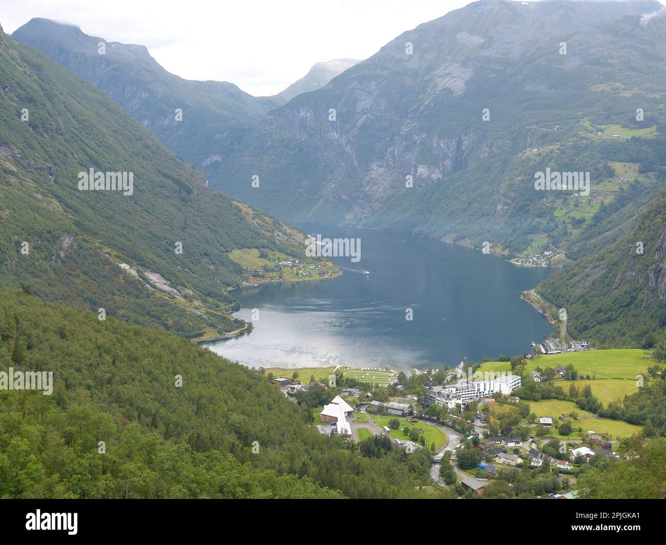 View from above into a valley with lake, houses, ships, campsite and ...