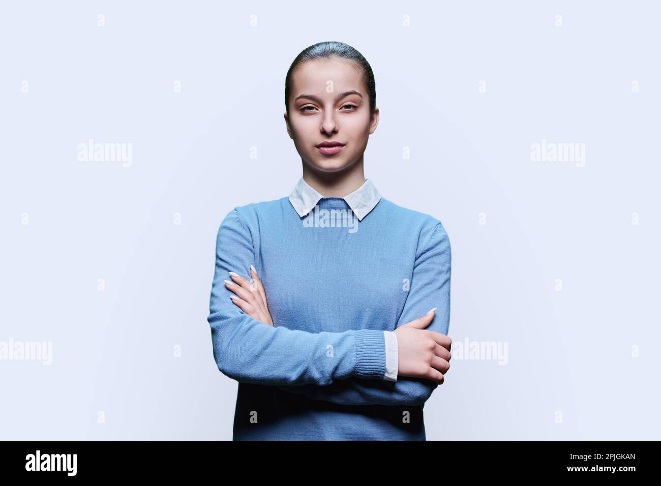 Portrait of serious high school student girl on white background Stock ...