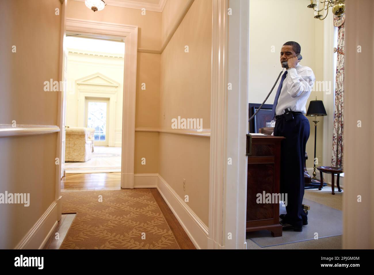 President Barack Obama takes a phone call in his private study off the ...