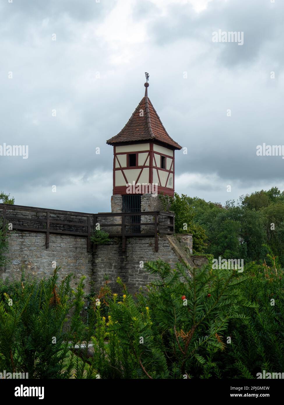 View of part of the old town wall with a lookout tower and bushes in ...