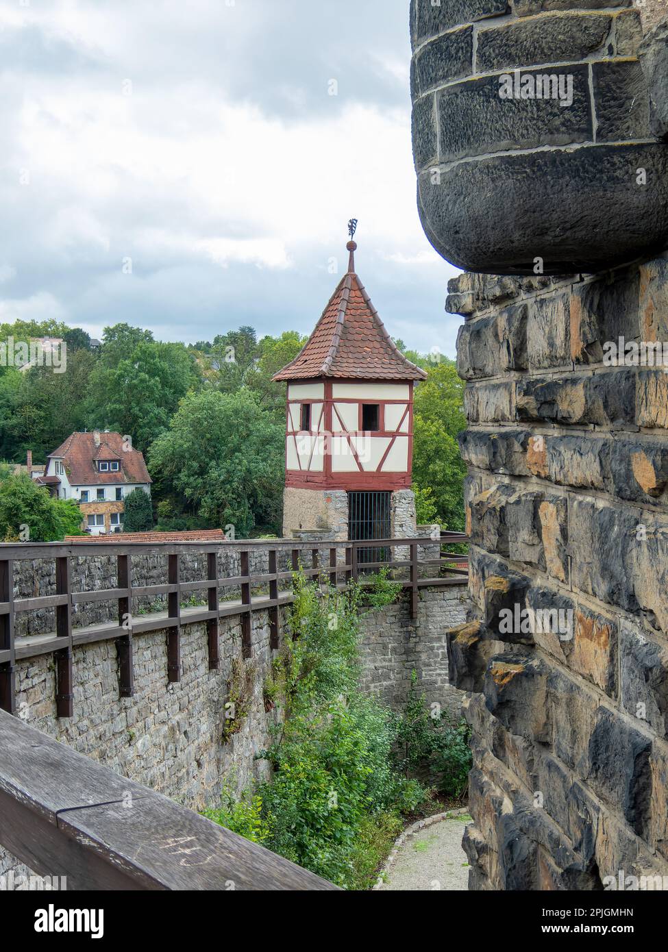 View of part of the old town wall with a lookout tower and bushes in ...