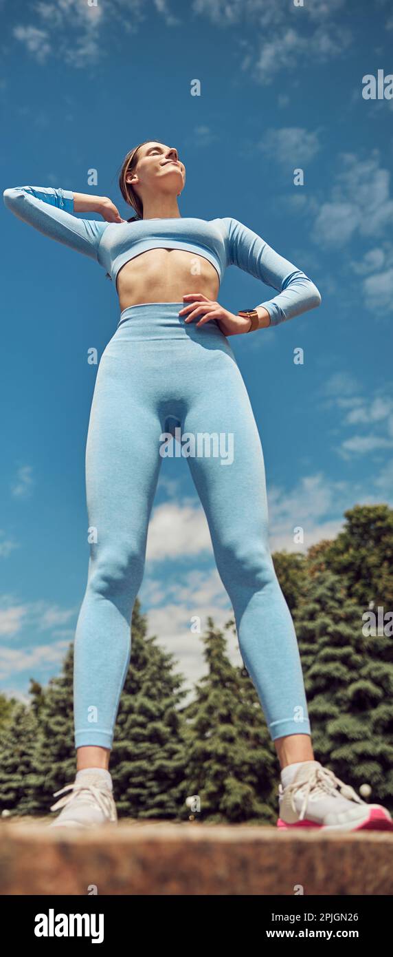 Beautiful fit young woman jogger is running outdoors Stock Photo - Alamy