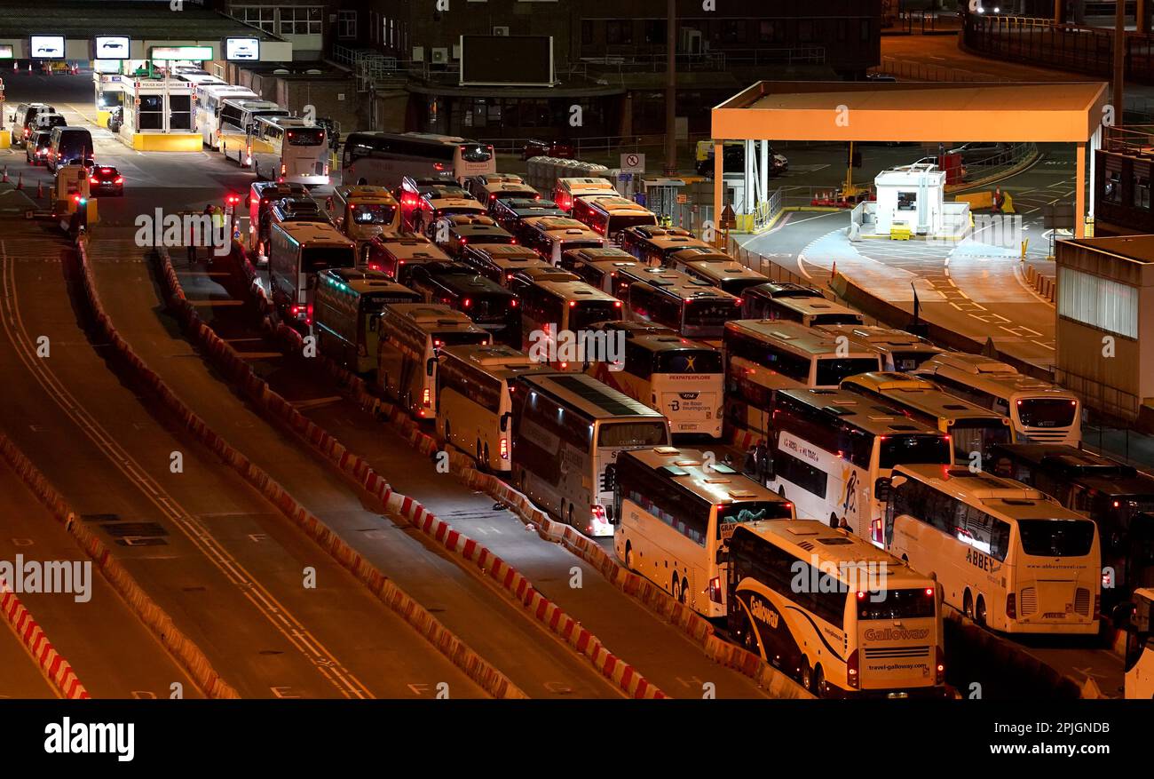 Coaches wait in to the evening to enter the Port of Dover in Kent after ...