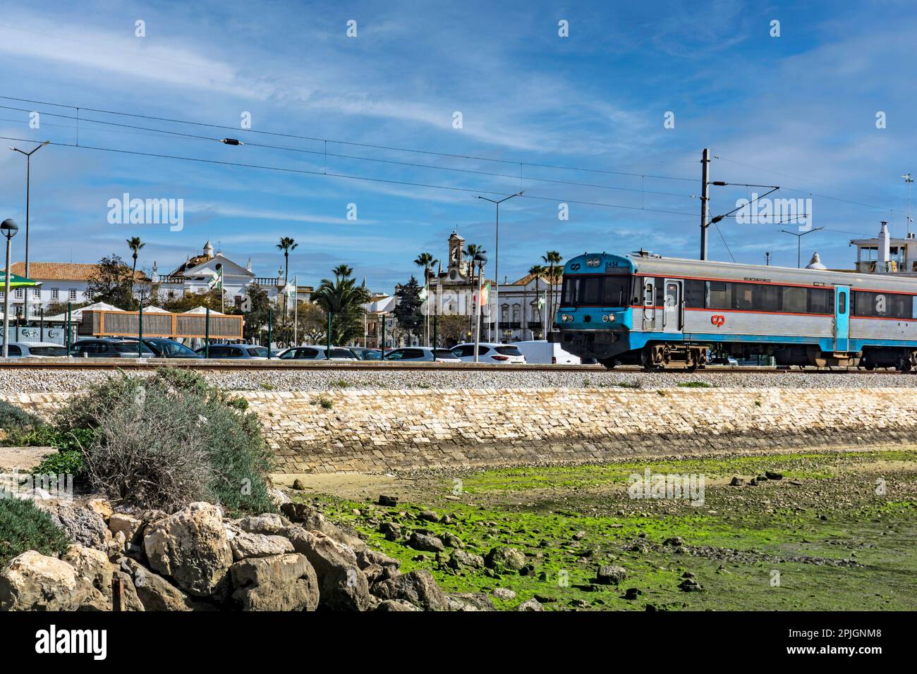 A train running alongside the nature reserve near Faro Airport ...