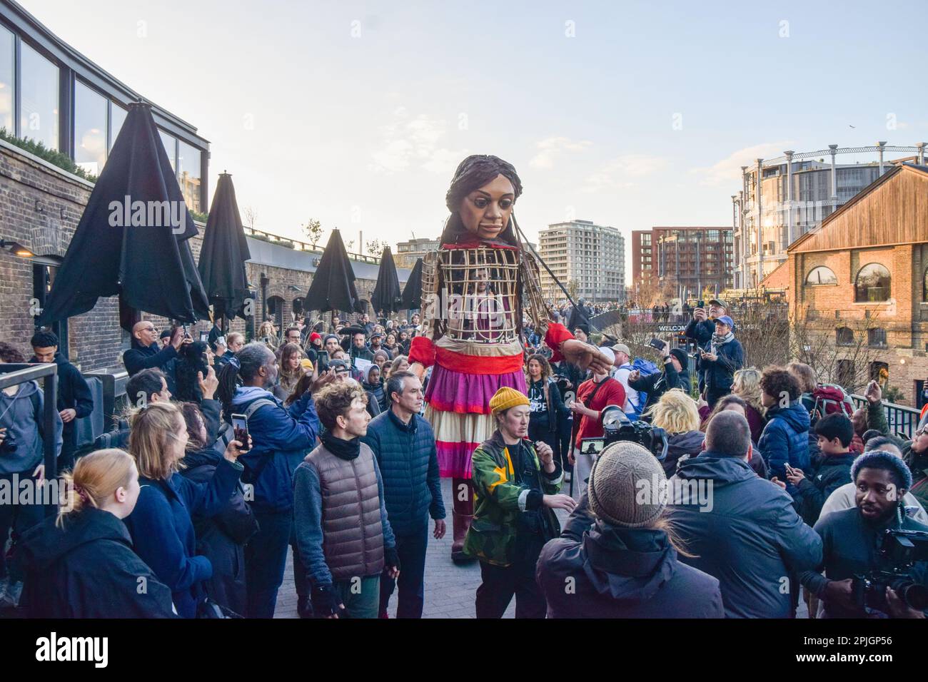 London, UK. 2nd April 2023. Crowds flock around Little Amal, the 3.5 ...