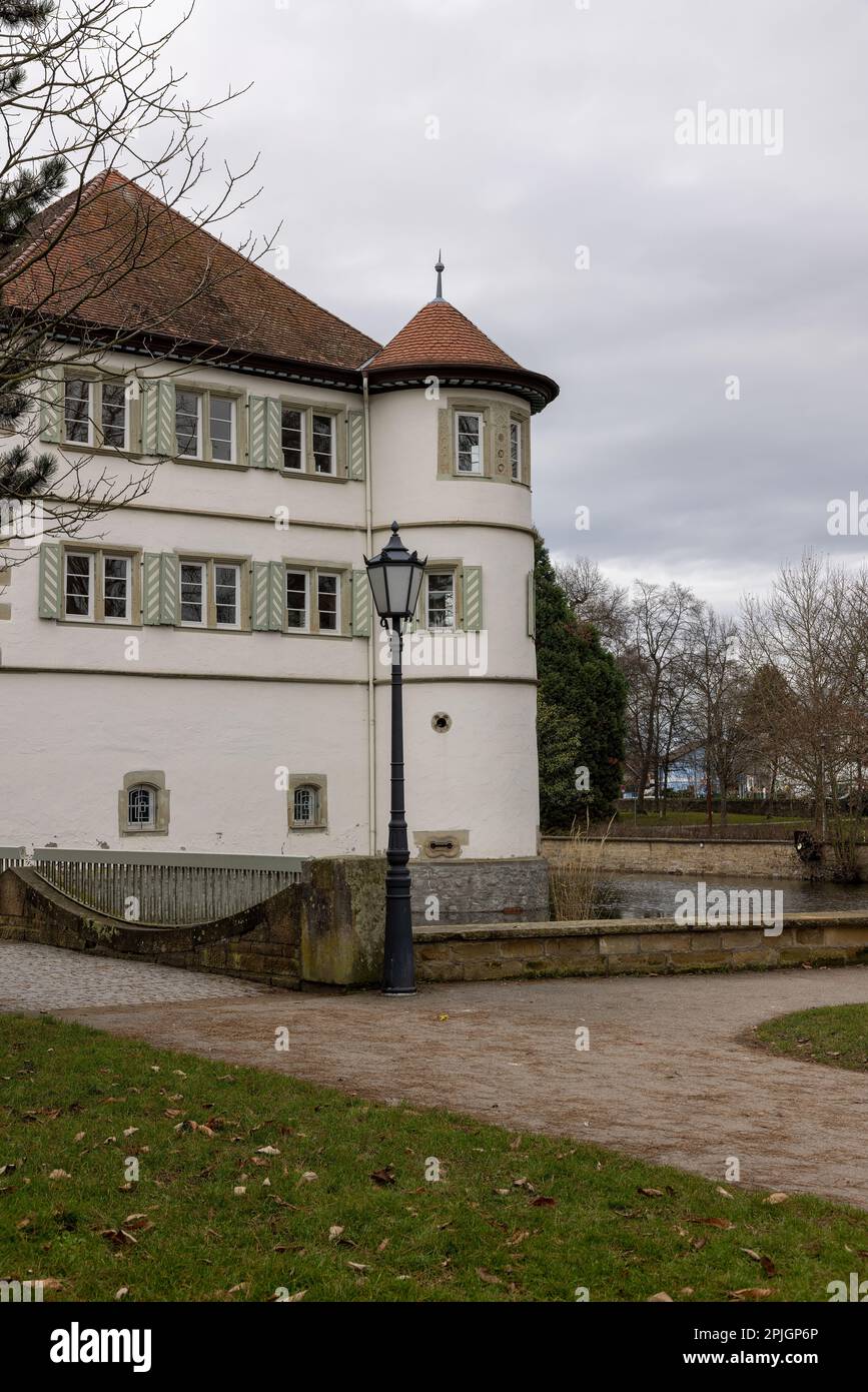 old moated castle of Bad Rappenau in winter with moat and reflection ...