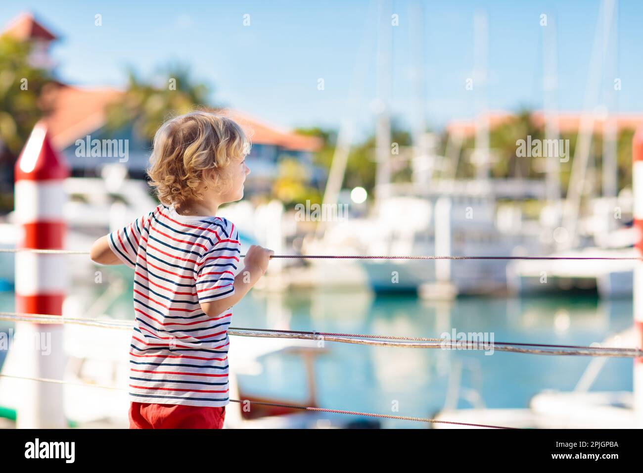 Child watching yacht and boat in harbor. Yachting sport for family with ...