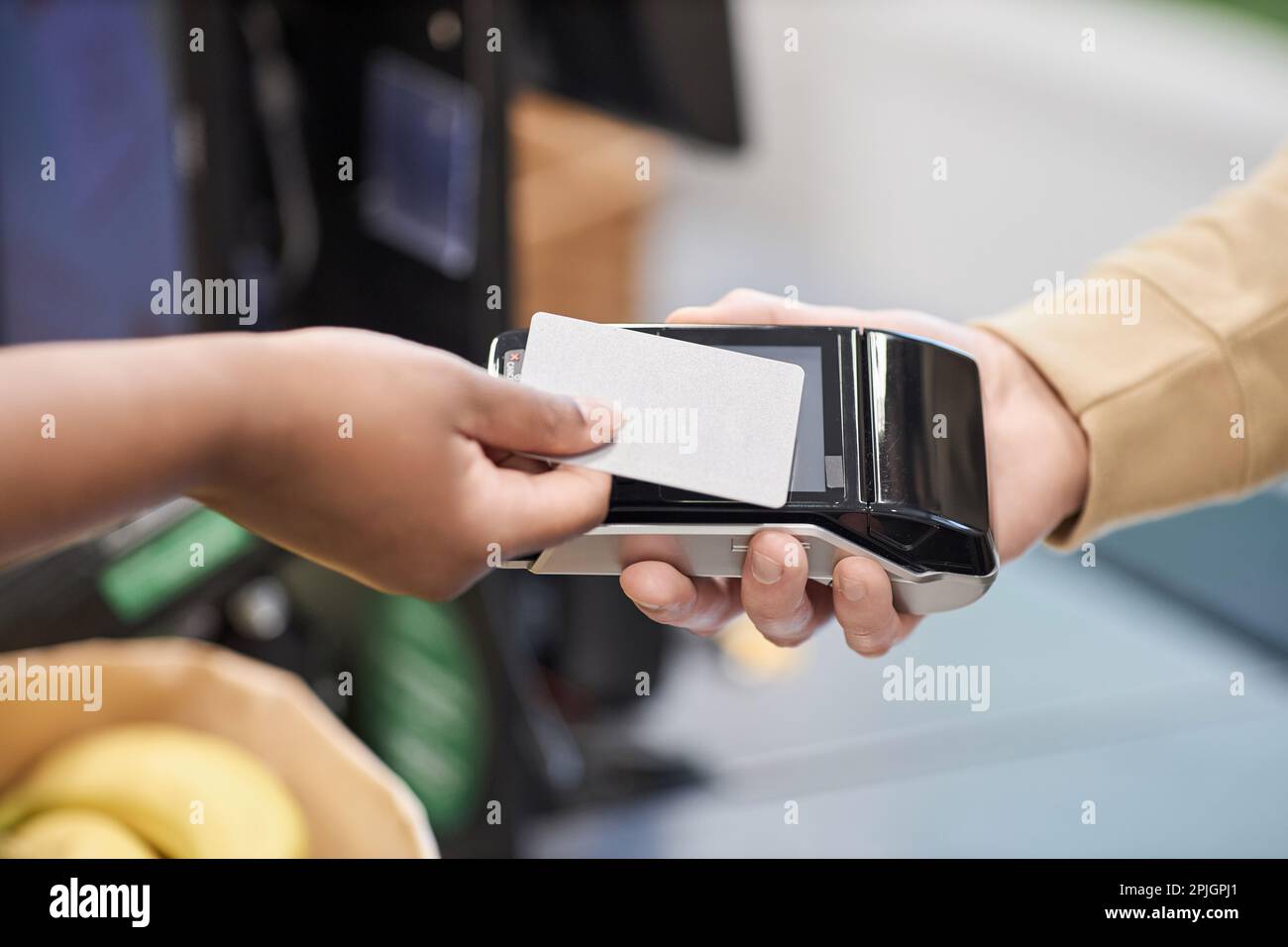 Close up of unrecognizable black woman paying via credit card mockup in supermarket, copy space ...