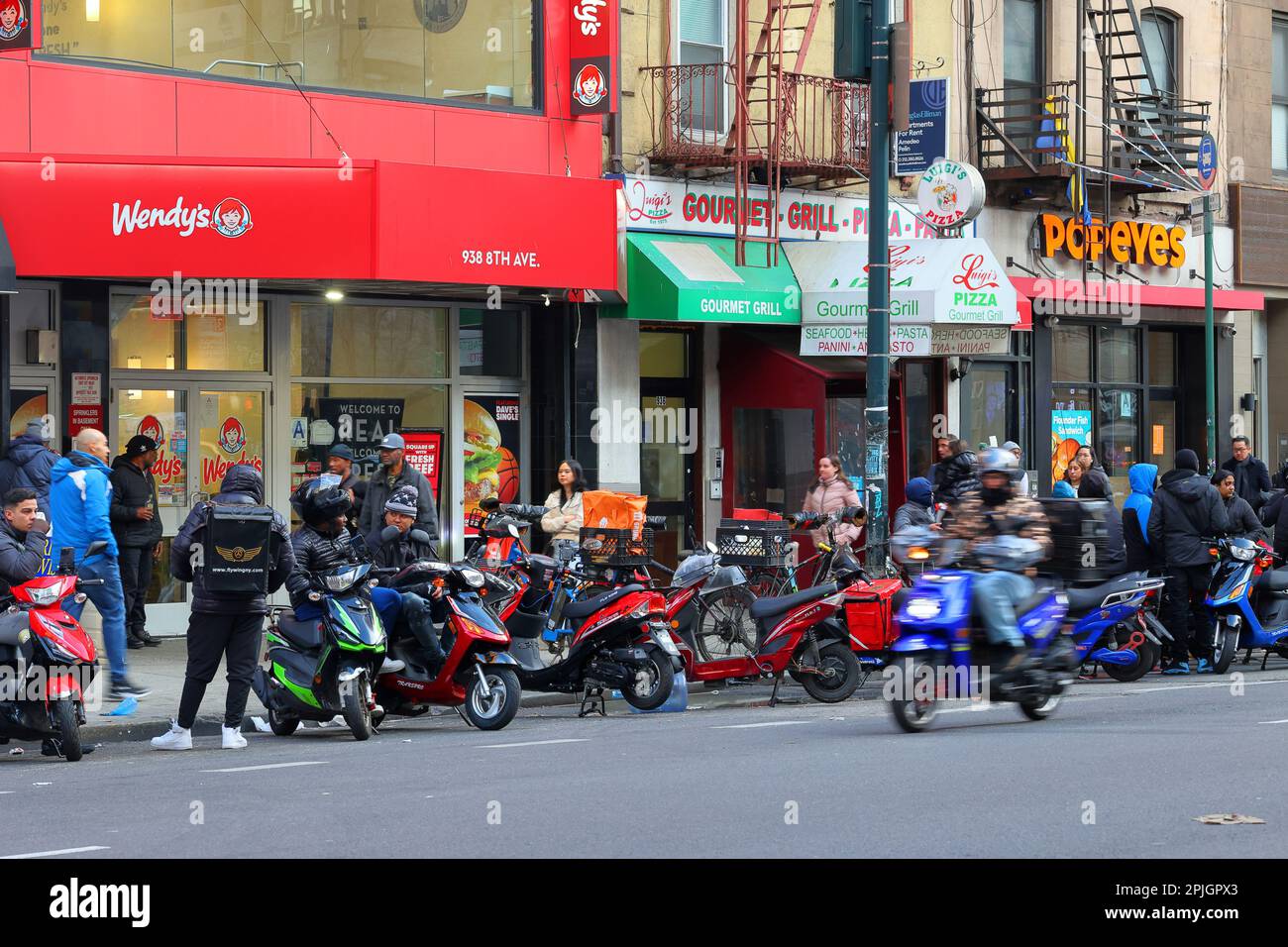 Gang of food delivery people with electric mopeds, electric escooters ...