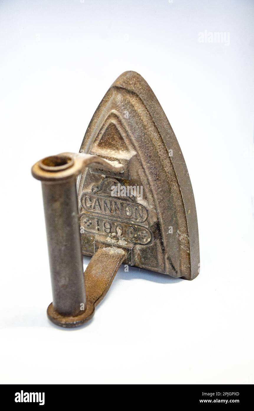 An old, antique iron for ironing clothes isolated against a white ...