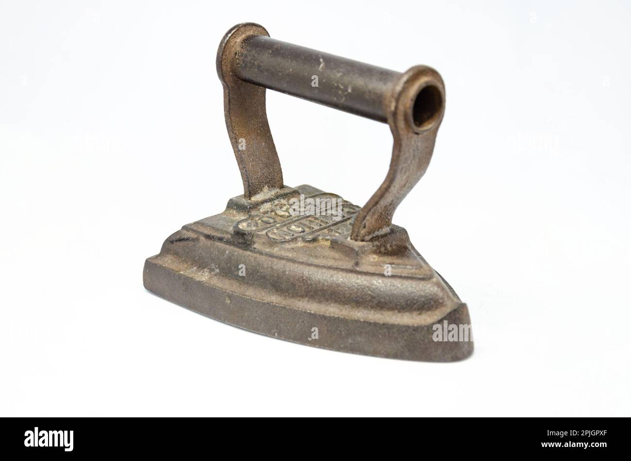 An old, antique iron for ironing clothes isolated against a white ...