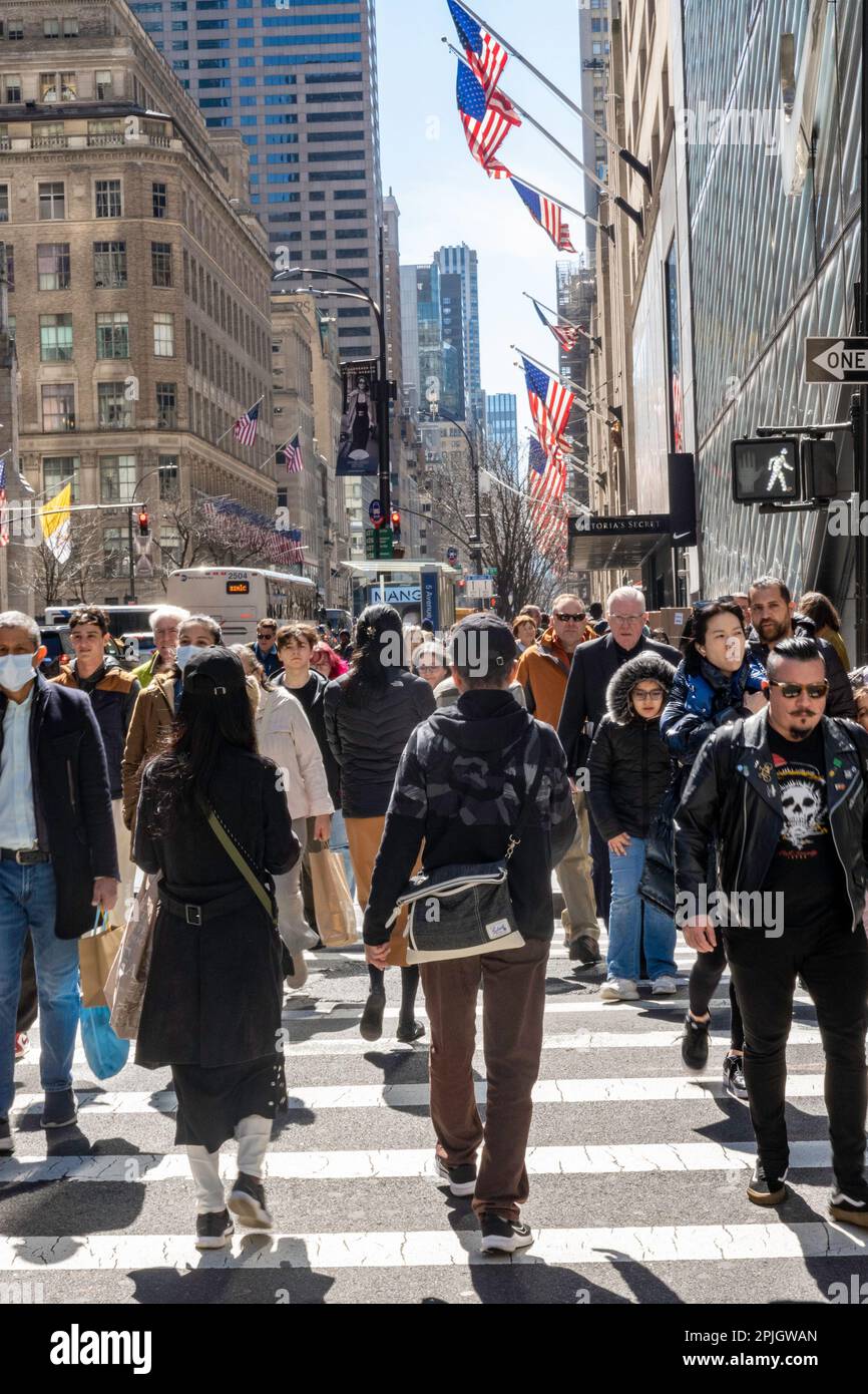 Pedestrians await a crosswalk on a crowded 5th Ave., Street corner ...