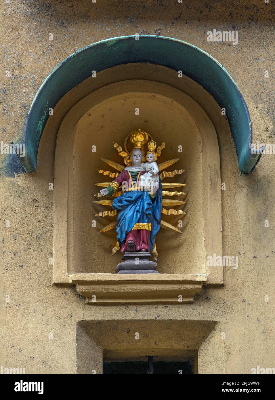 Sculpture of Mary with the Child Jesus in a niche on a residential ...