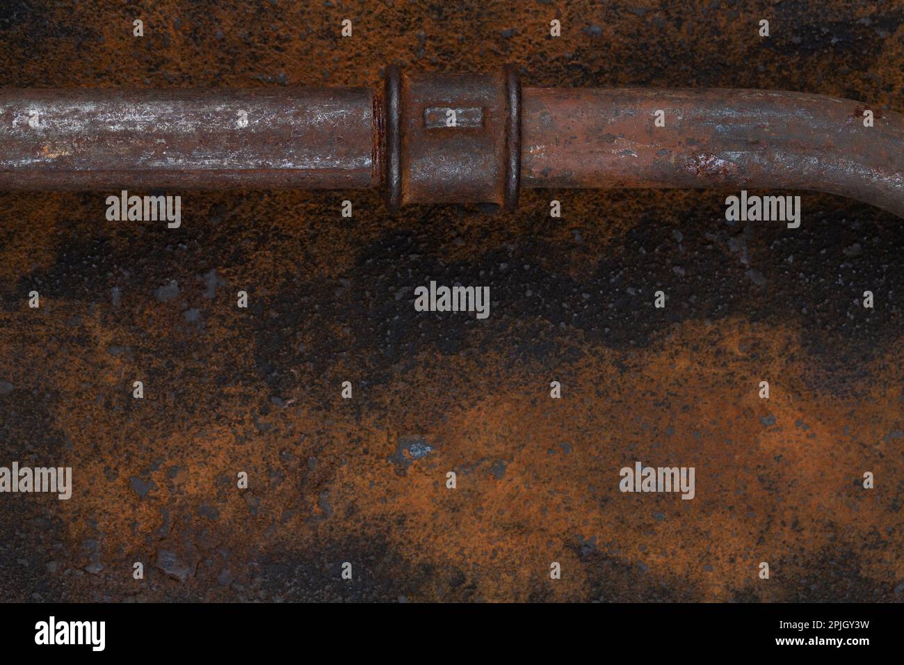 Rusty valve pipes on rusty metal wall background Stock Photo - Alamy