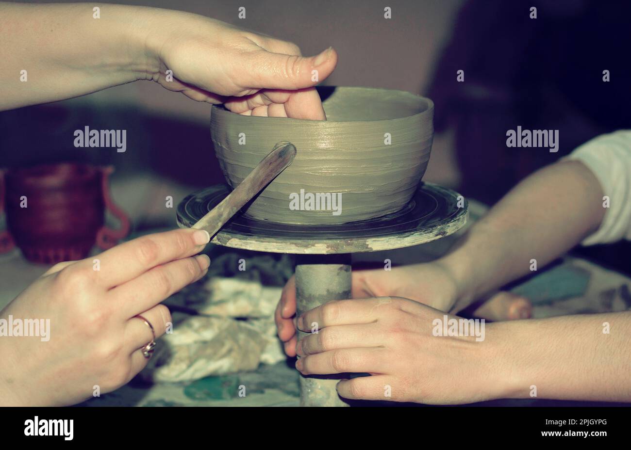 Potter master on a wheel makes products of clay Stock Photo - Alamy