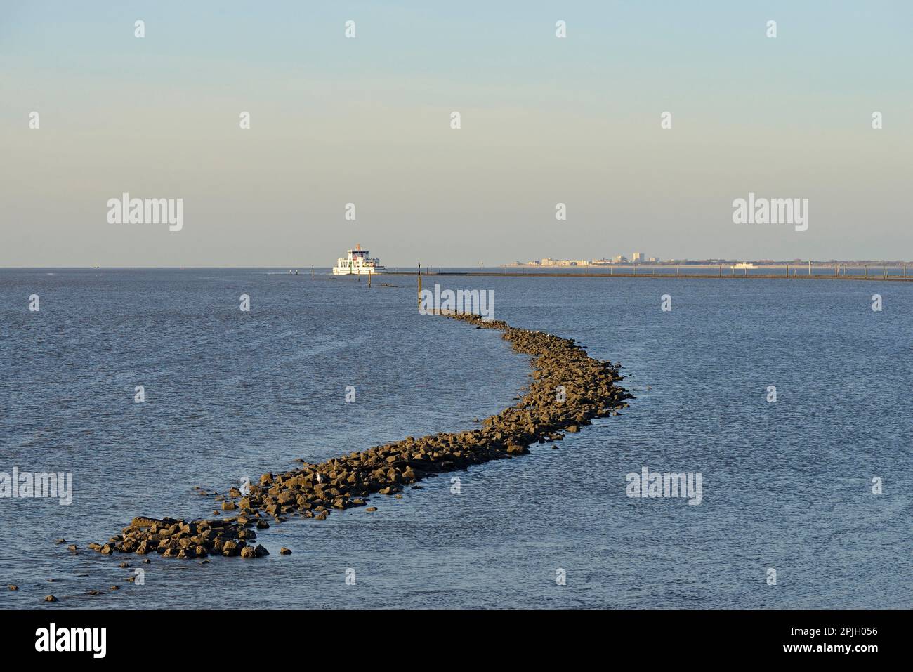 Stone groyne as coastal protection, on the horizon Norderney Island ...