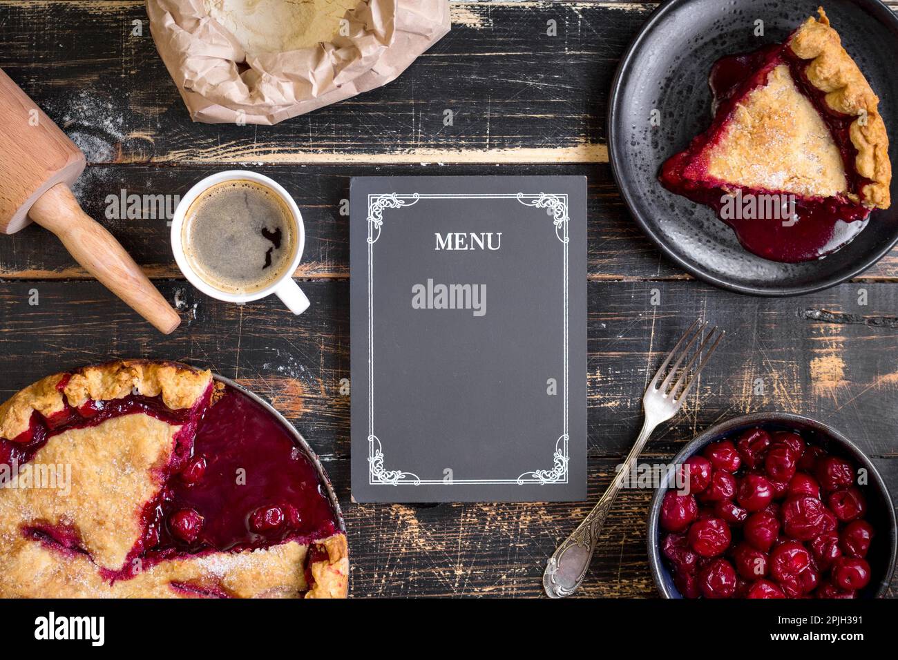 Baking background with sliced cherry pie, flour, rolling pin and menu ...