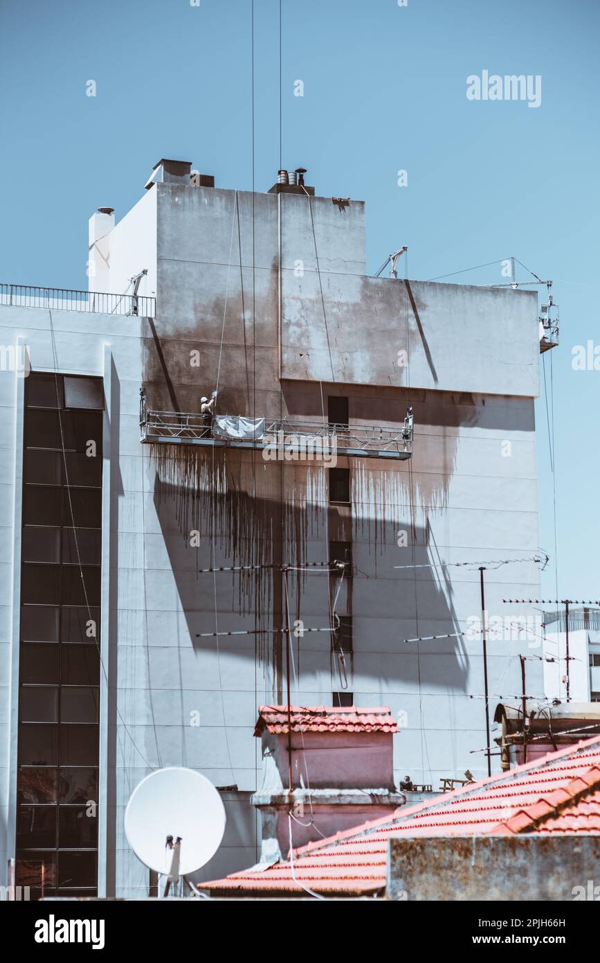 A vertical shot captures an apartment wall being cleaned; Blackened ...
