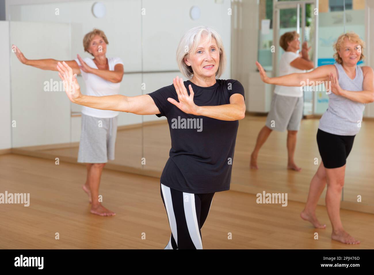 Positive aged woman practicing vigorous dance movements Stock Photo - Alamy