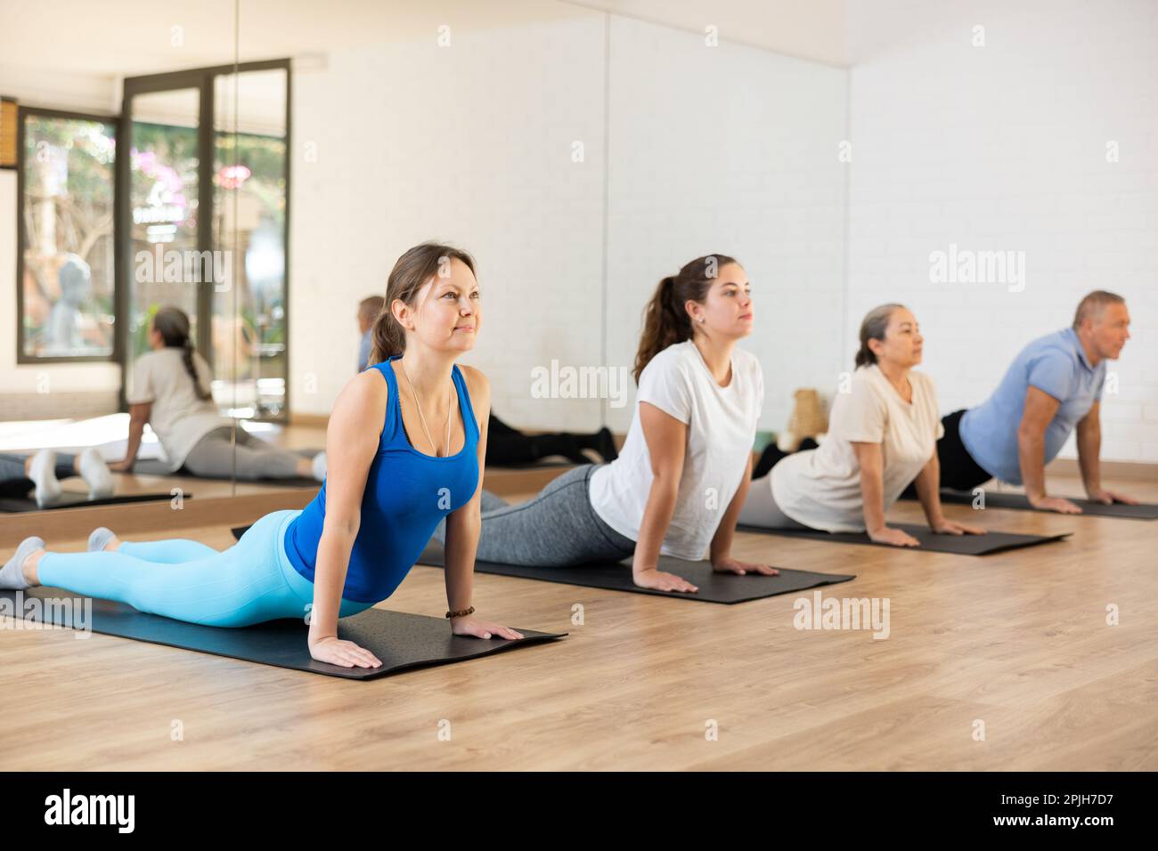 Woman performing back bending asana Urdhva Mukha Shvanasana Stock Photo ...
