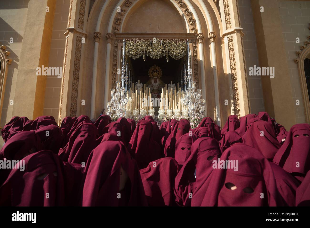 Penitents carry a throne with a statue of Christ as they take part in ...