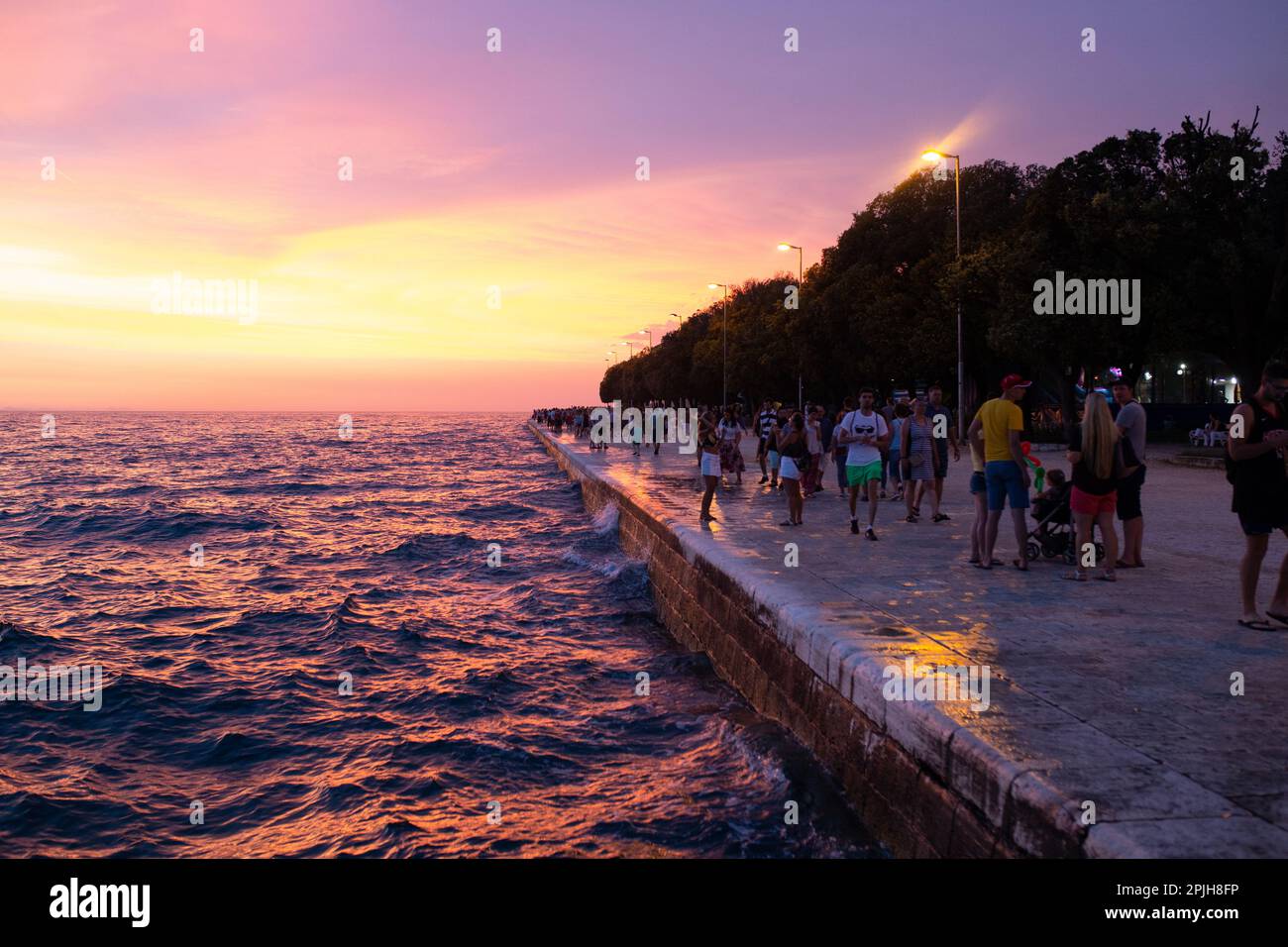 Crowds of people watch the sunset every night in the beautiful historic ...