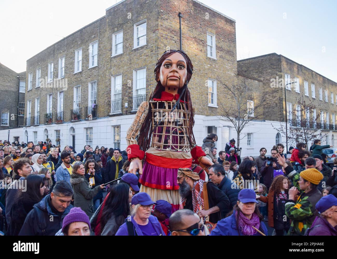 London, UK. 2nd April 2023. Crowds flock around Little Amal, the 3.5 ...
