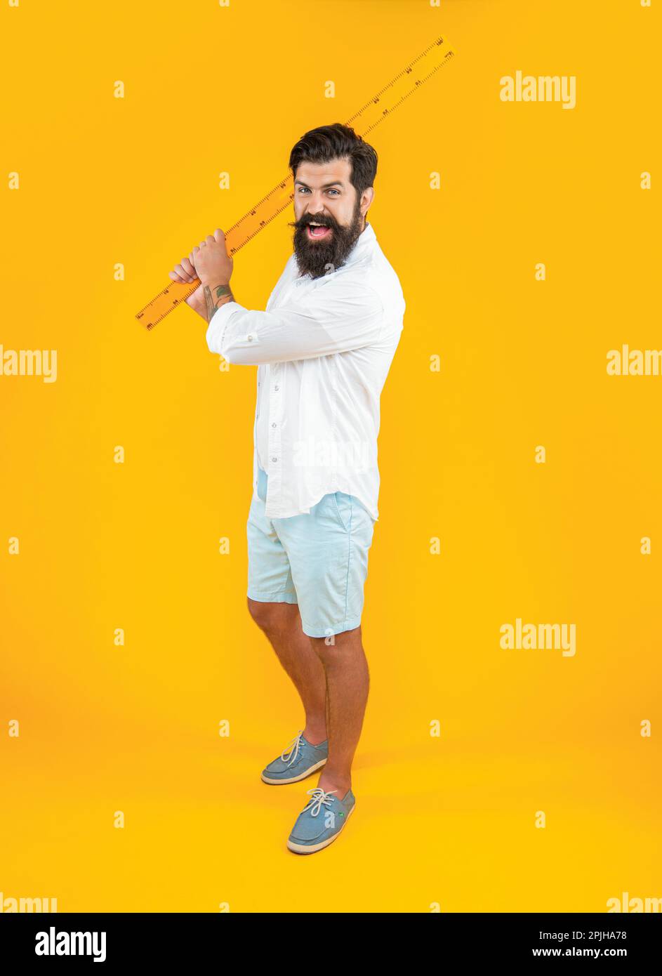 aggressive man with measuring ruler in studio. man with measuring ruler ...