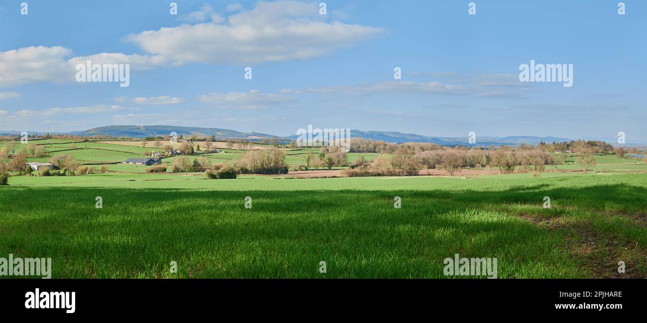Panoramic image of english country side with clouds in blue sky Stock ...