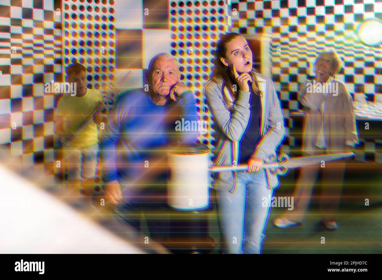 Kids and grandparents thinking about conundrum solution in escape room ...