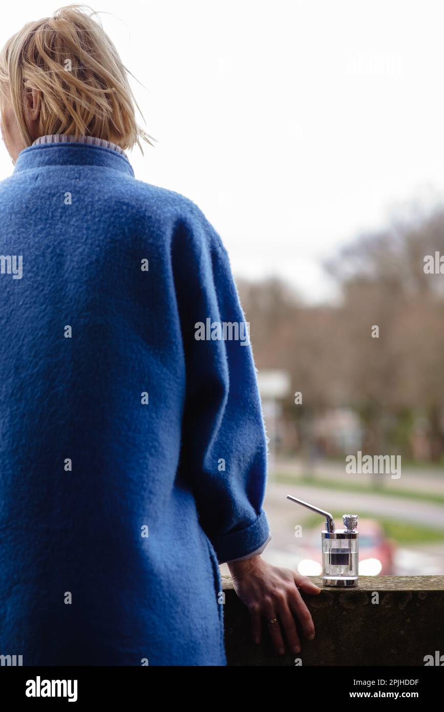 woman and device for smoking cannabis. An unrecognizable woman is on ...